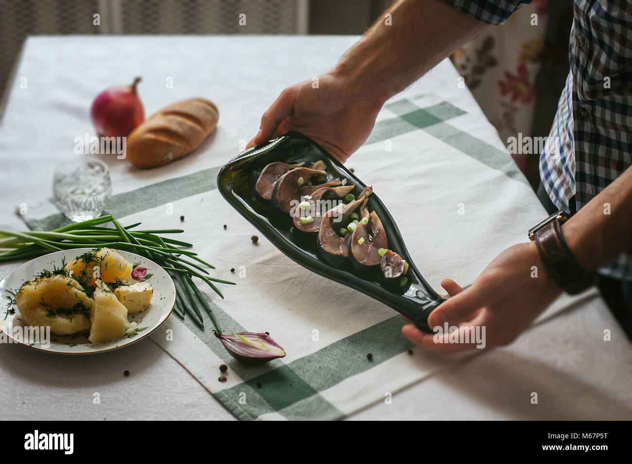 Only hands. Man finishing her plate and almost ready to serve at the ...