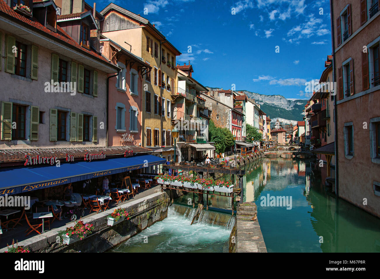 Old and colorful buildings facing the canal, in Annecy. An historical ...