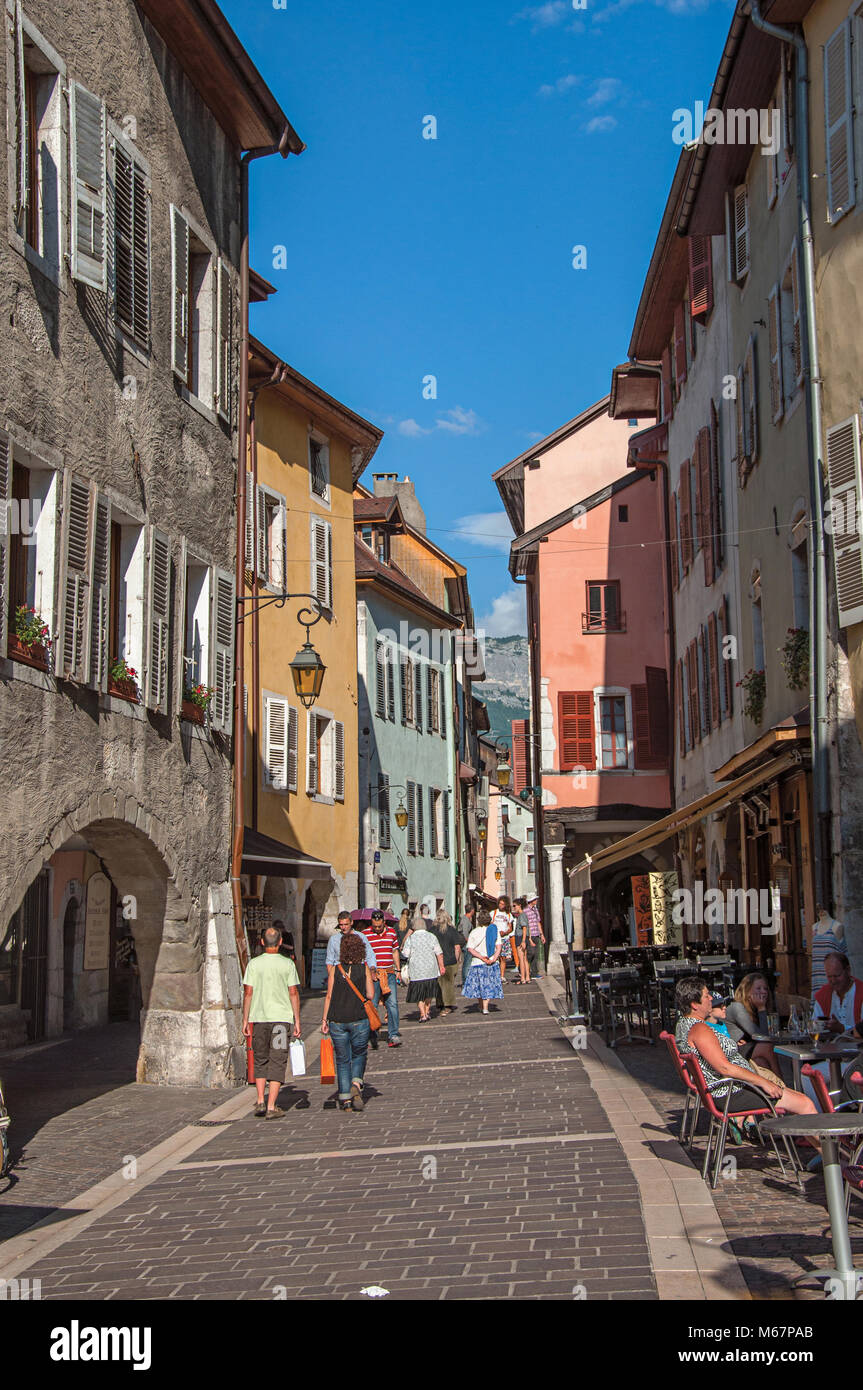 Colorful old buildings and pedestrians, in the city center of Annecy ...