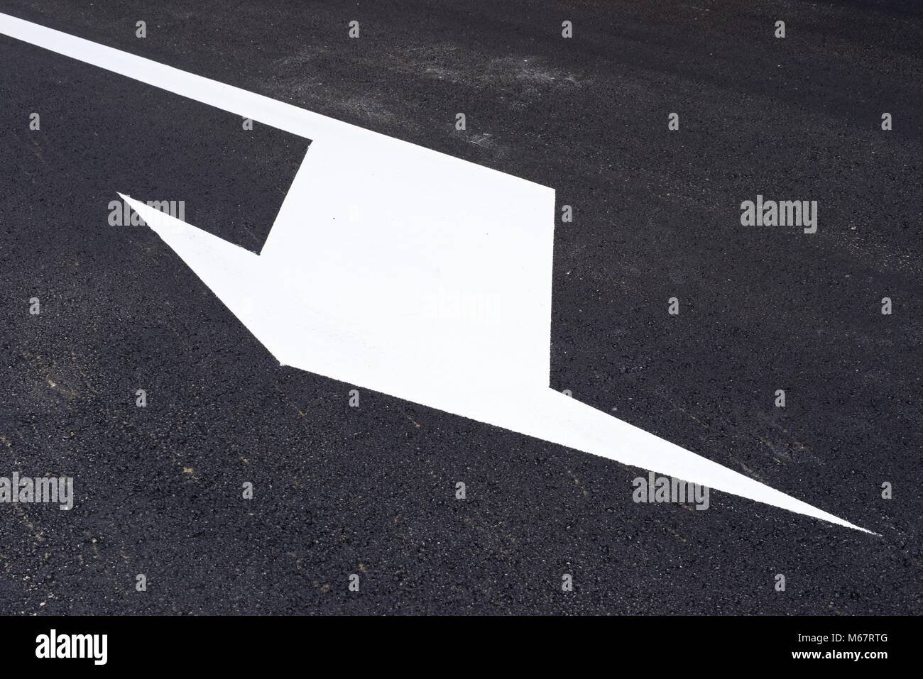 Single arrow directional sign on the floor Stock Photo - Alamy