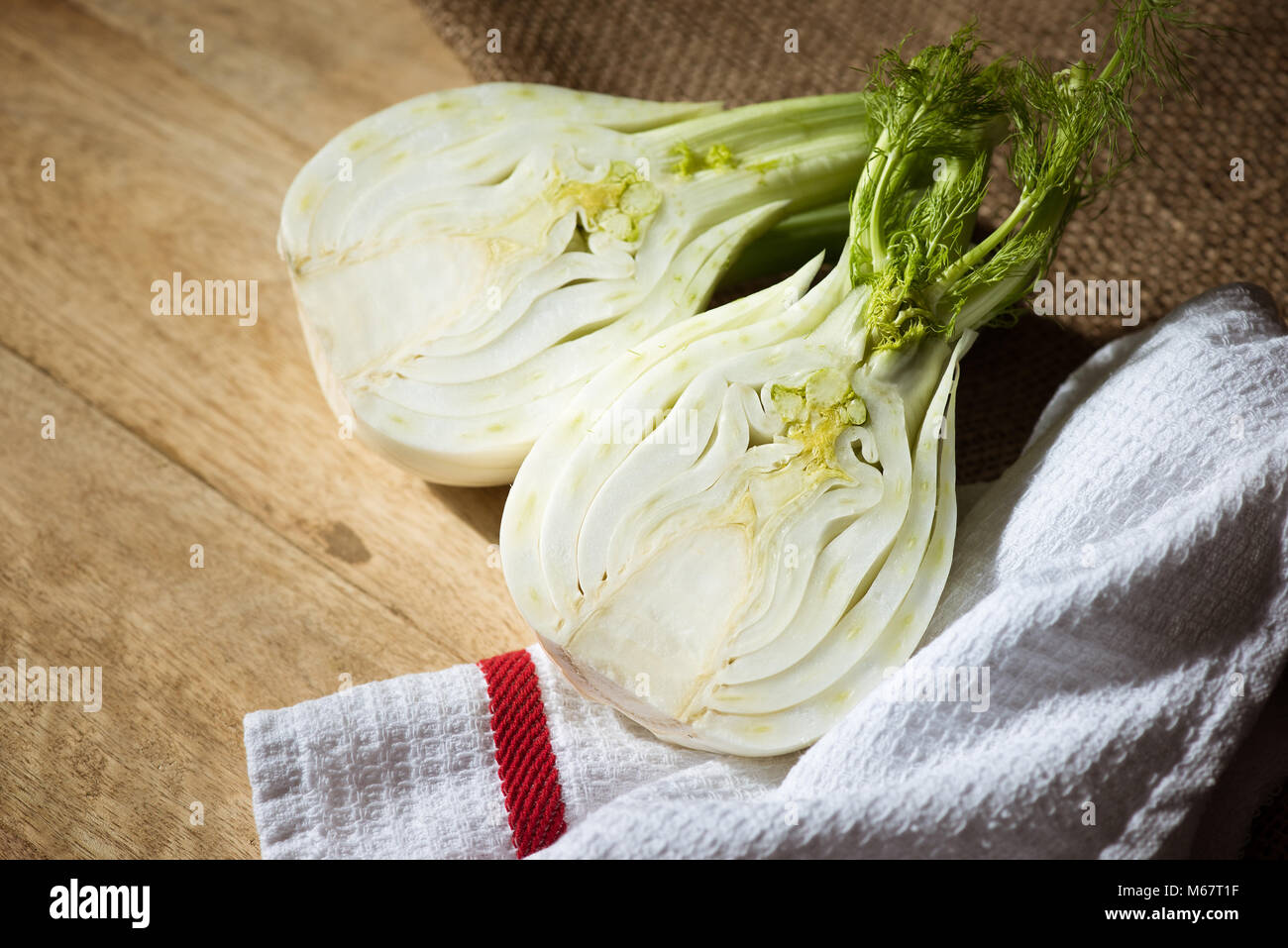Fennel cross section, two halves, on wooden table Stock Photo - Alamy