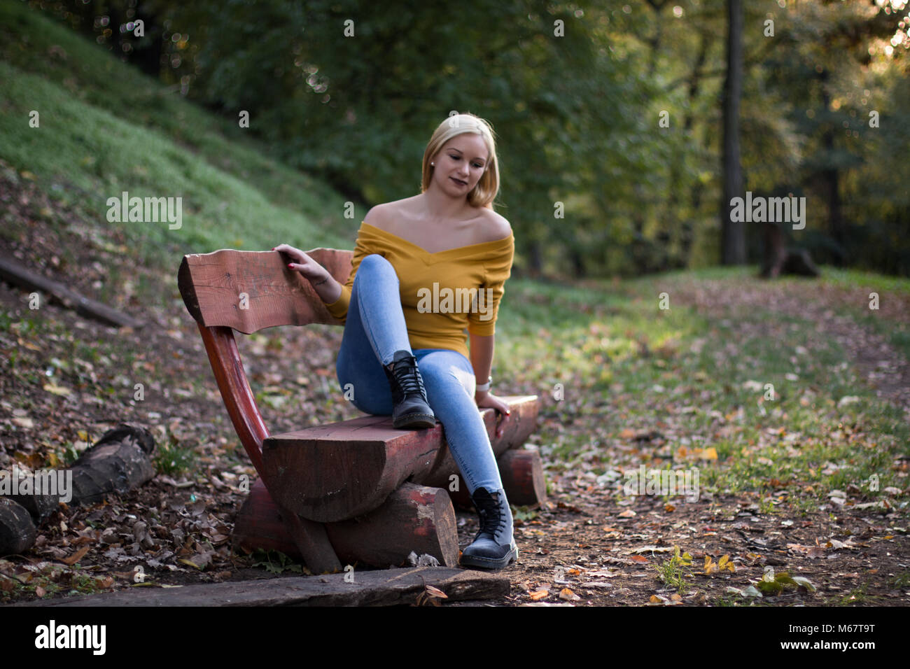 Blonde girl on park bench hi-res stock photography and images - Alamy