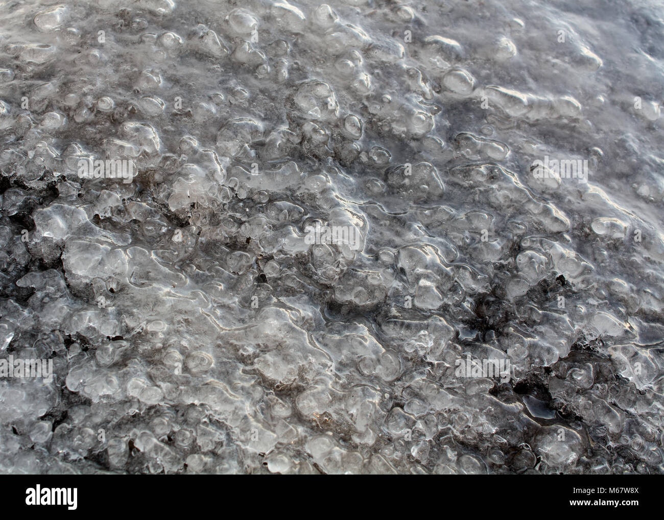 Frozen water forming ice crystals in icy landscape in winter ...