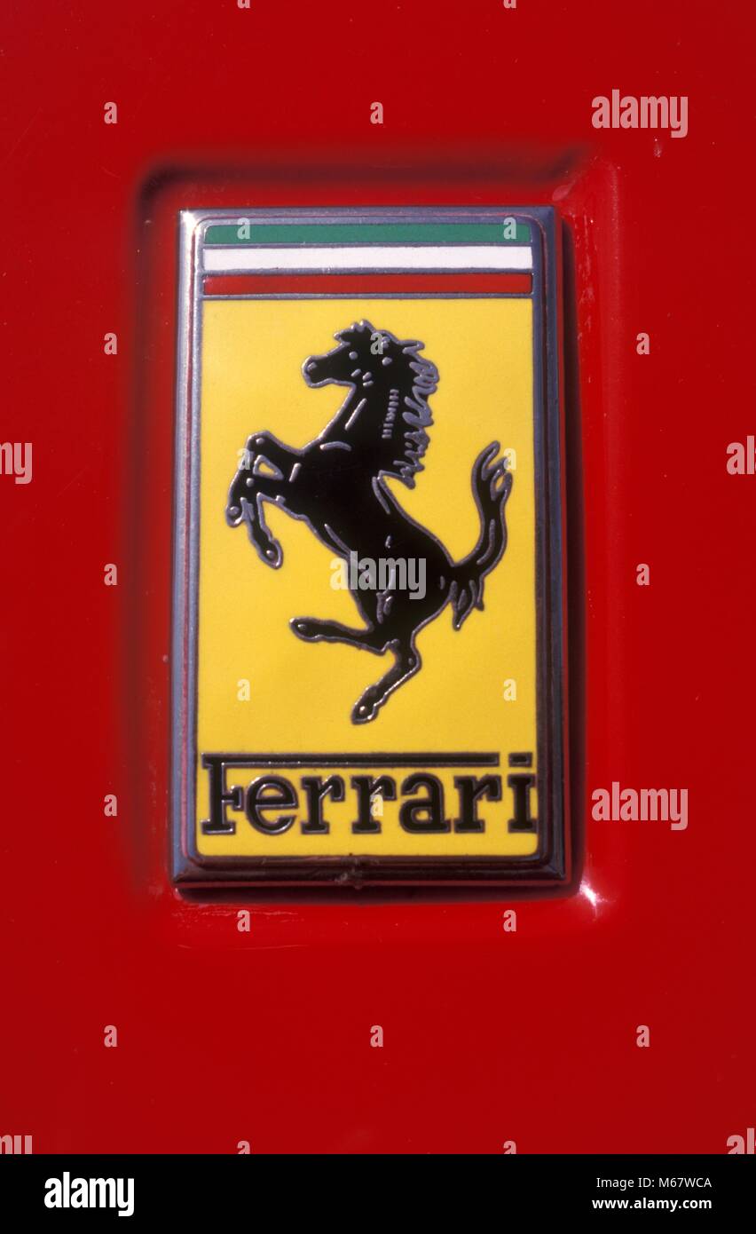 A Ferrari badge on a red car close up detail Stock Photo - Alamy