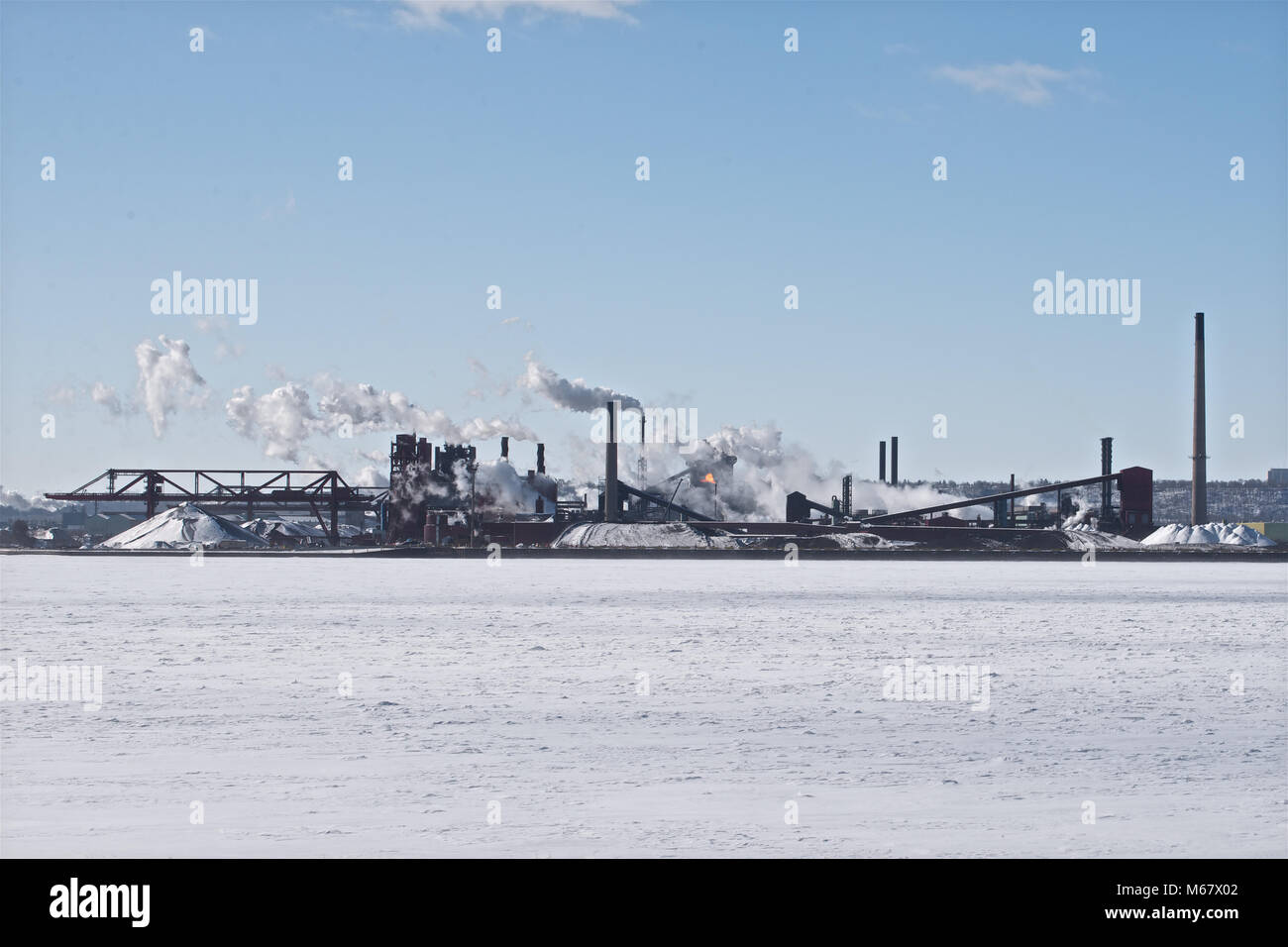 The steel mills viewed across a frozen Hamilton Harbour, Ontario ...