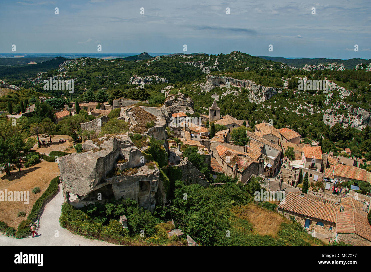 View of the Baux-de-Provence castle ruins on the hill, with roofs of ...