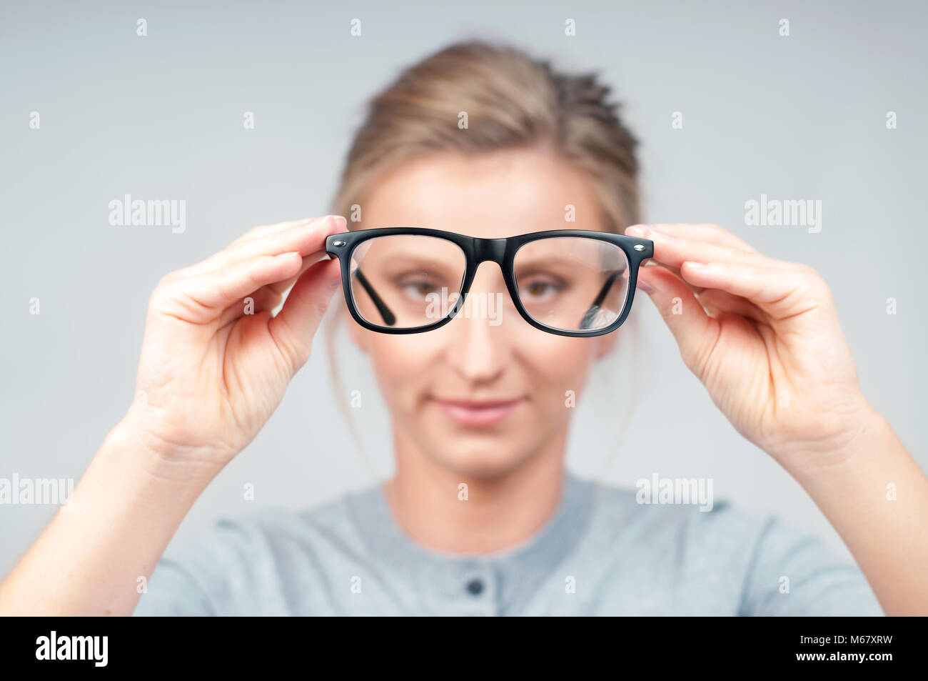 Closeup of glasses. Woman optician with eyeglasses and frame in focus Stock Photo - Alamy