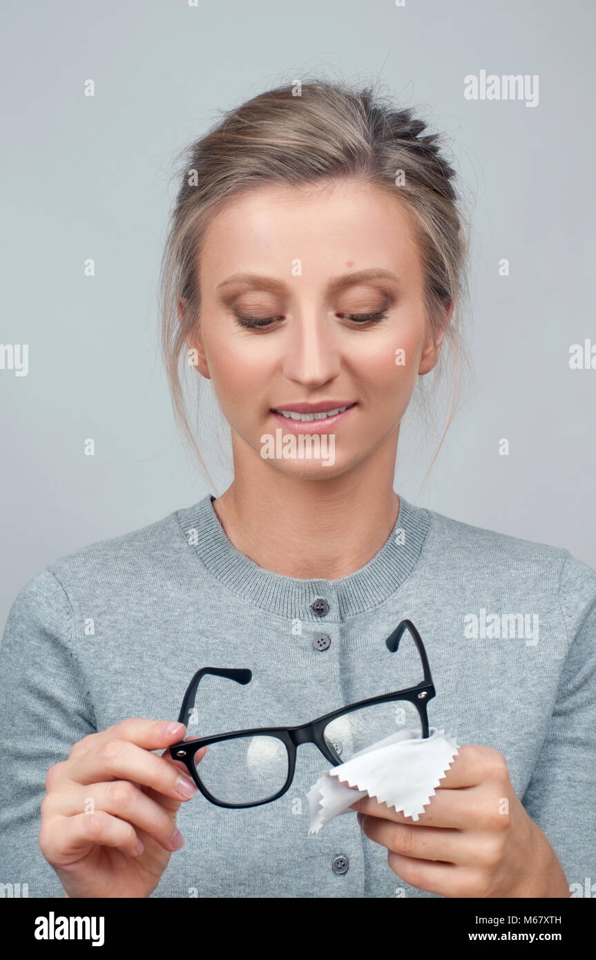 Beautiful young woman checking new eyeglasses Stock Photo - Alamy