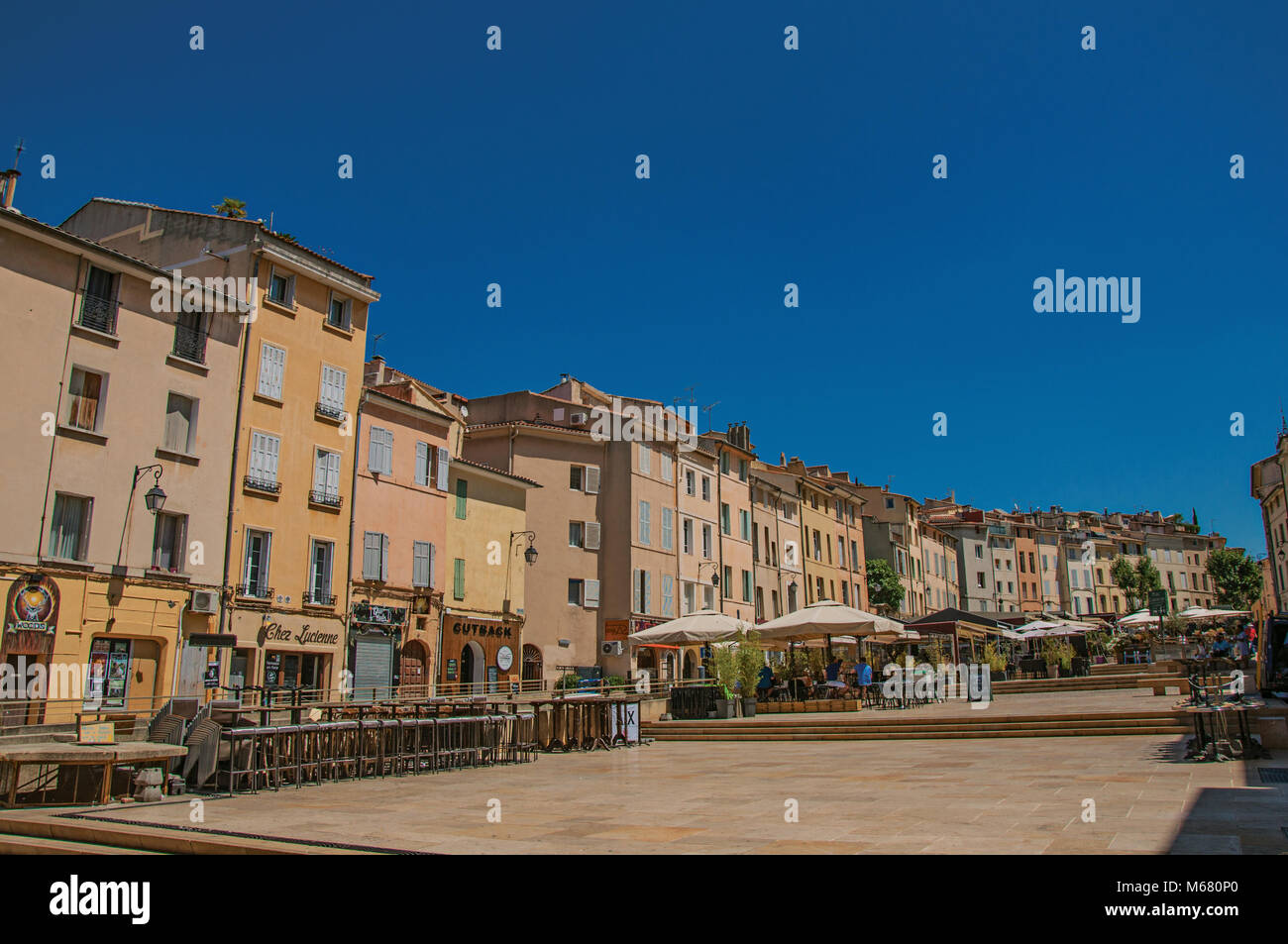 Square with colorful buildings and restaurant umbrella in Aix-en ...