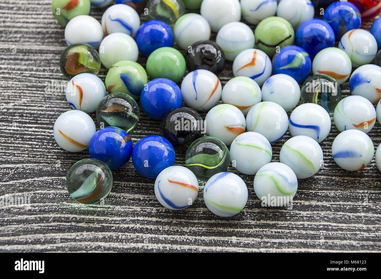 A baby playing with glass marbles, colored glass marble, hundreds of ...