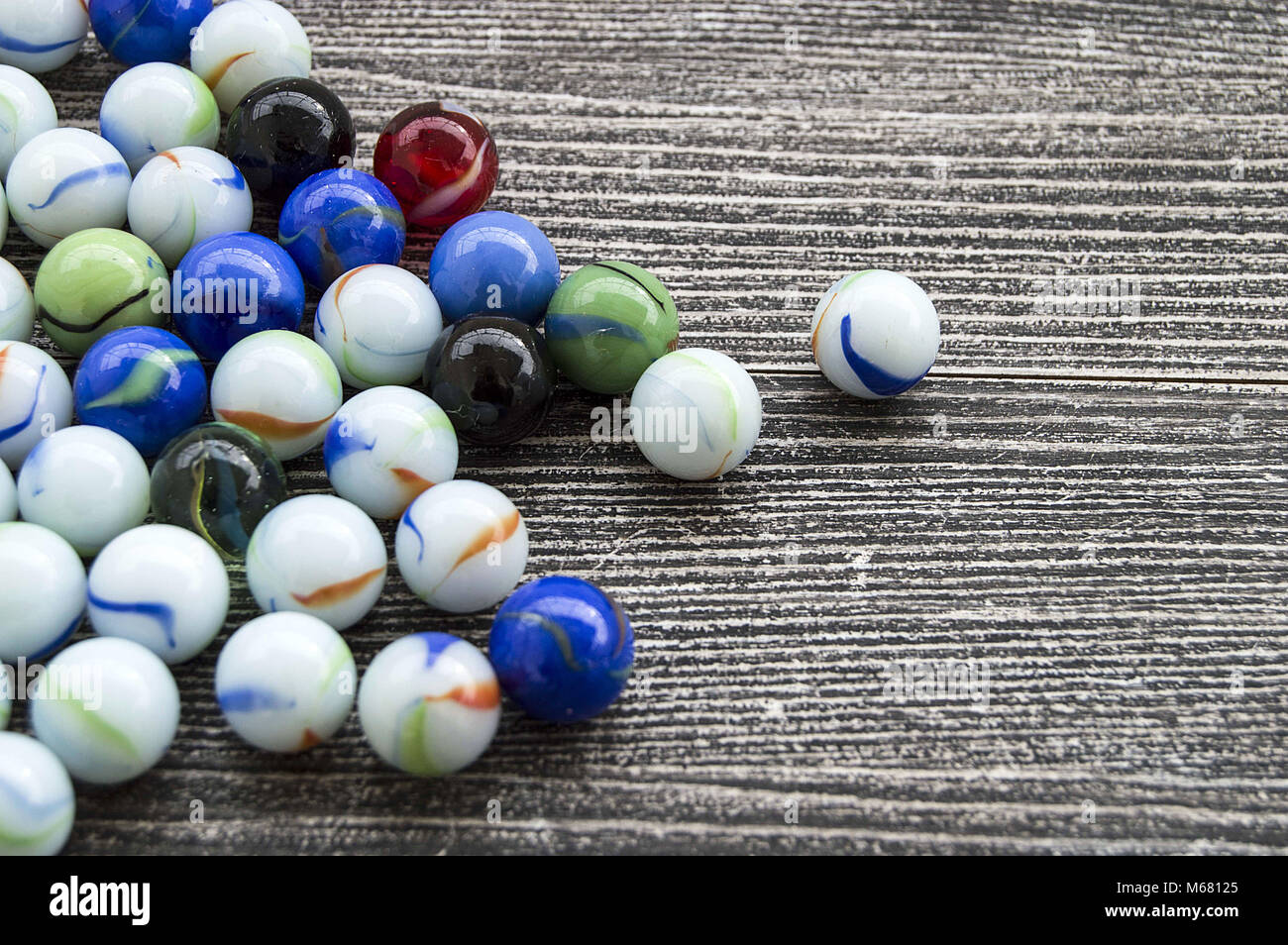 A baby playing with glass marbles, colored glass marble, hundreds of ...
