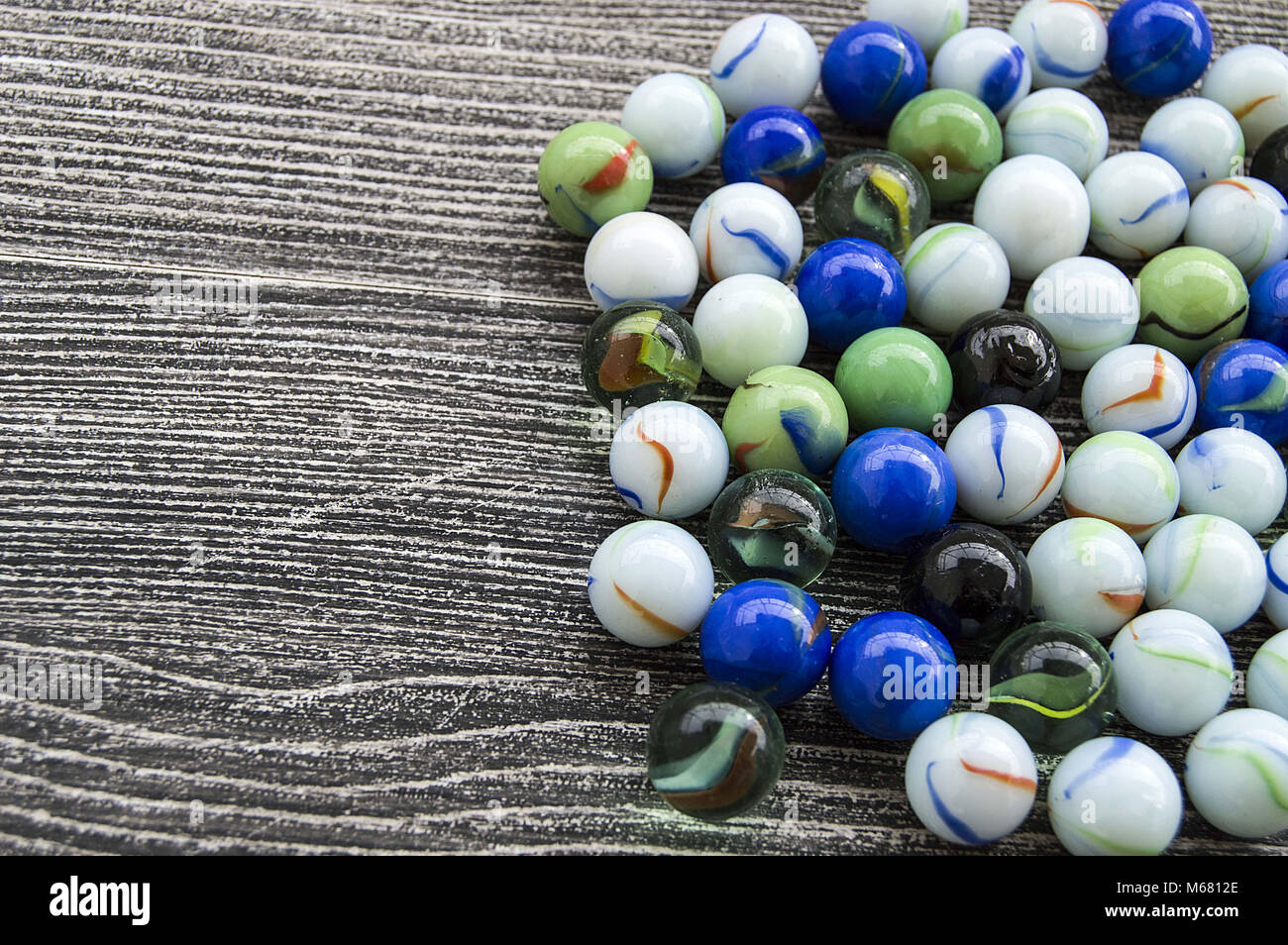 A baby playing with glass marbles, colored glass marble, hundreds of ...