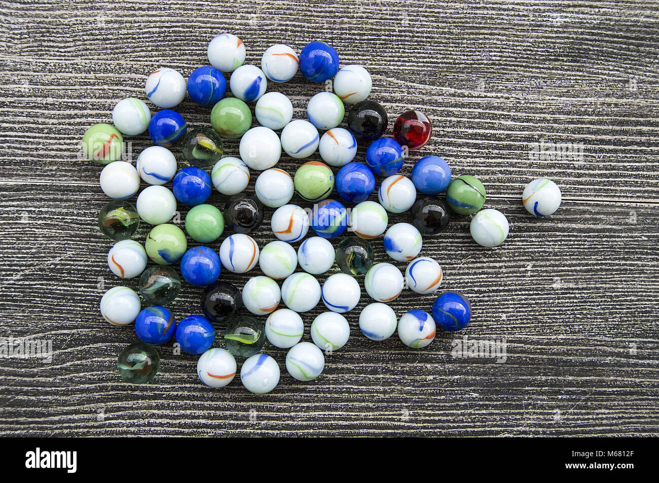 A baby playing with glass marbles, colored glass marble, hundreds of ...