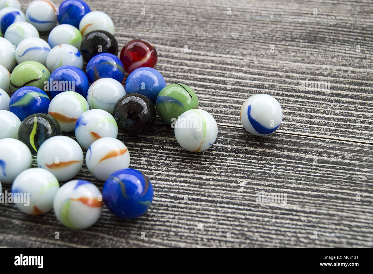 A baby playing with glass marbles, colored glass marble, hundreds of ...