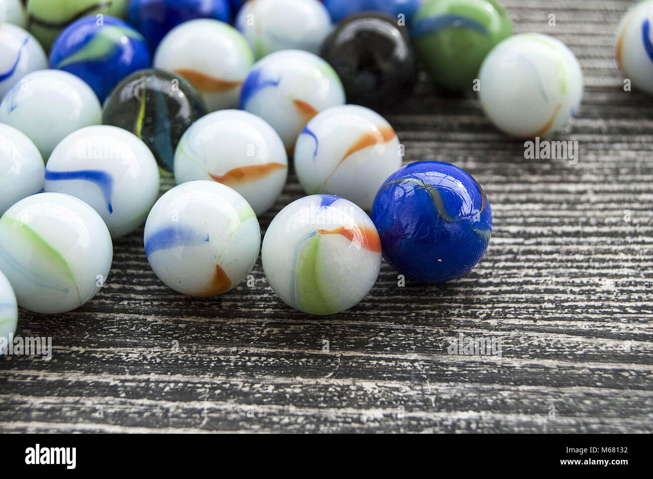 A baby playing with glass marbles, colored glass marble, hundreds of ...