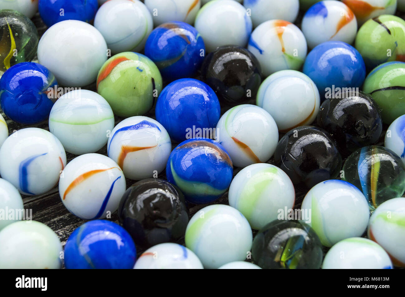 glass marble bag, marble bag on black ground, a baby is playing with ...