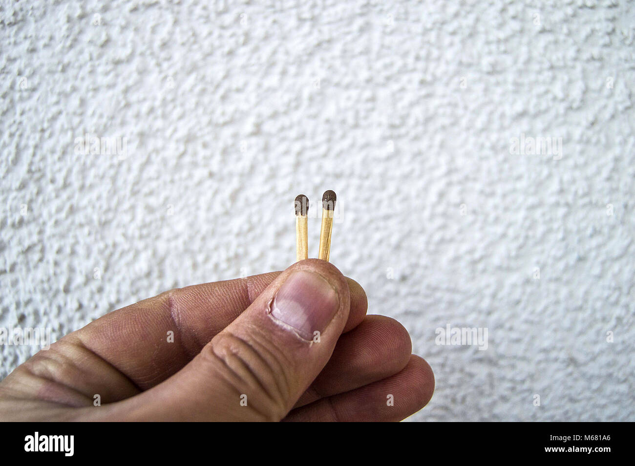 Man holding a matchstick, there are dozens of matchstick in one hand ...