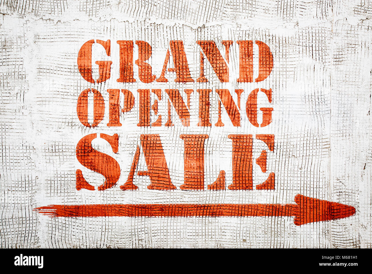 Grand opening sale - red graffiti sign with arrow on a white stucco ...