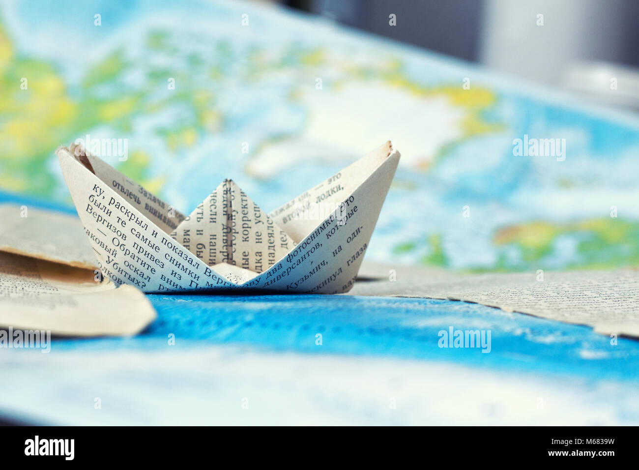 a paper ship goes on a journey . travel of a paper ship Stock Photo - Alamy