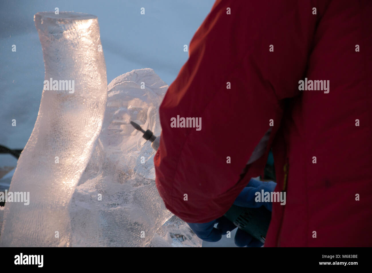 Ice carver uses a drill on a carving in progress during the Ice Magic ...