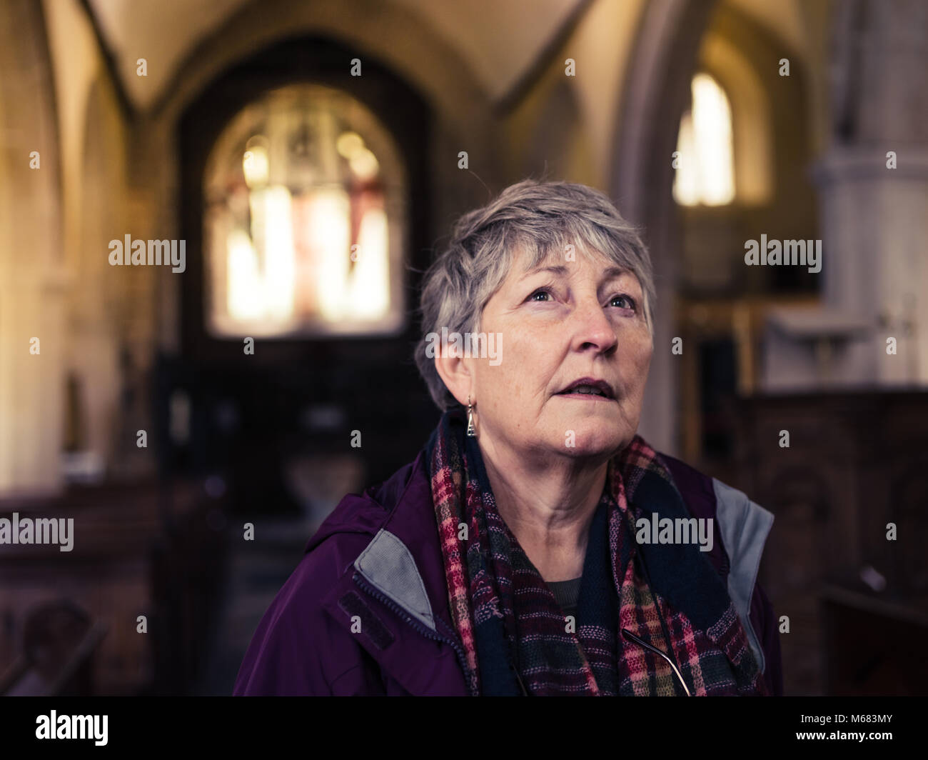 A senior woman is exploring a church Stock Photo - Alamy
