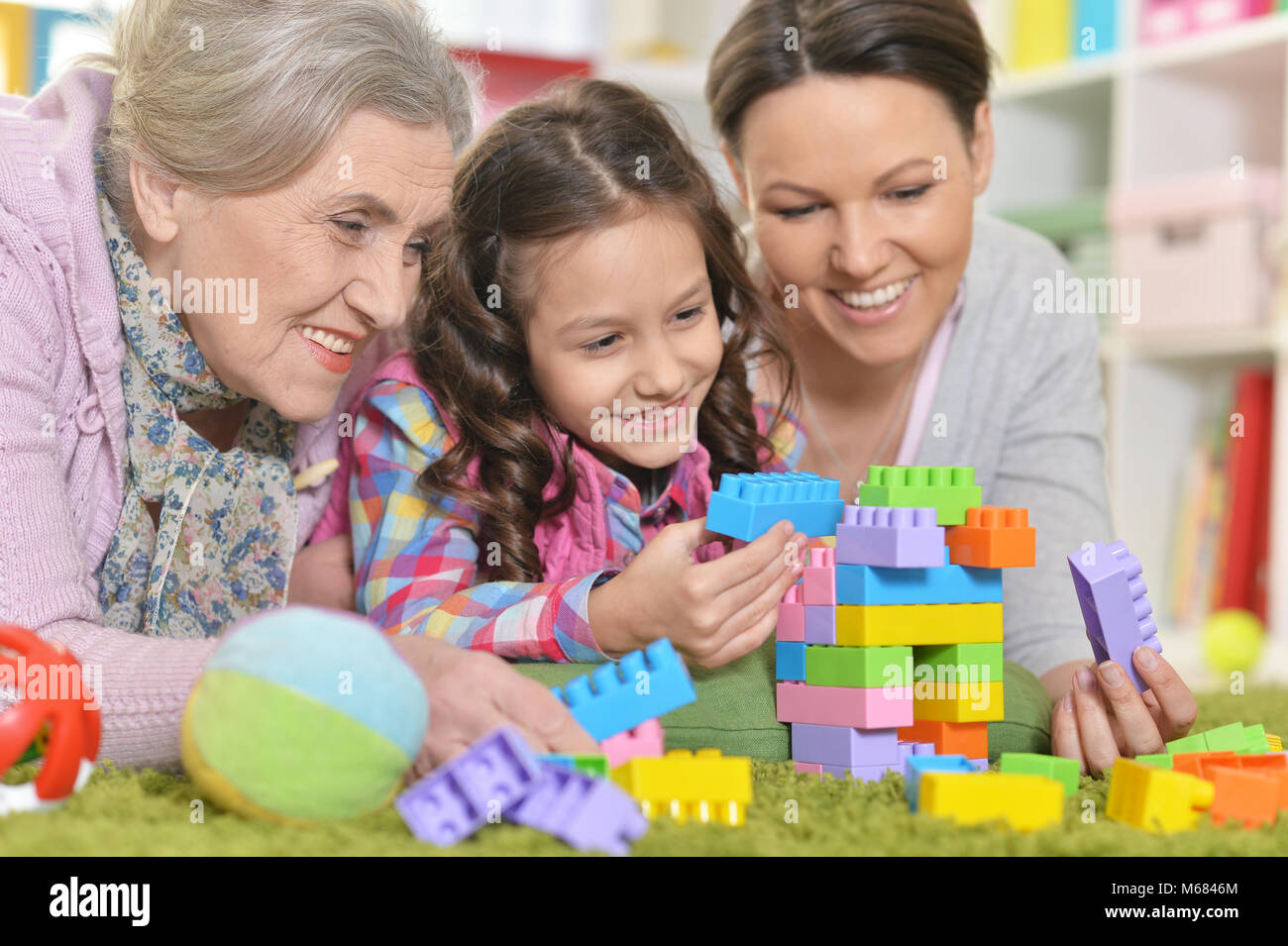 family playing with colorful plastic blocks Stock Photo - Alamy