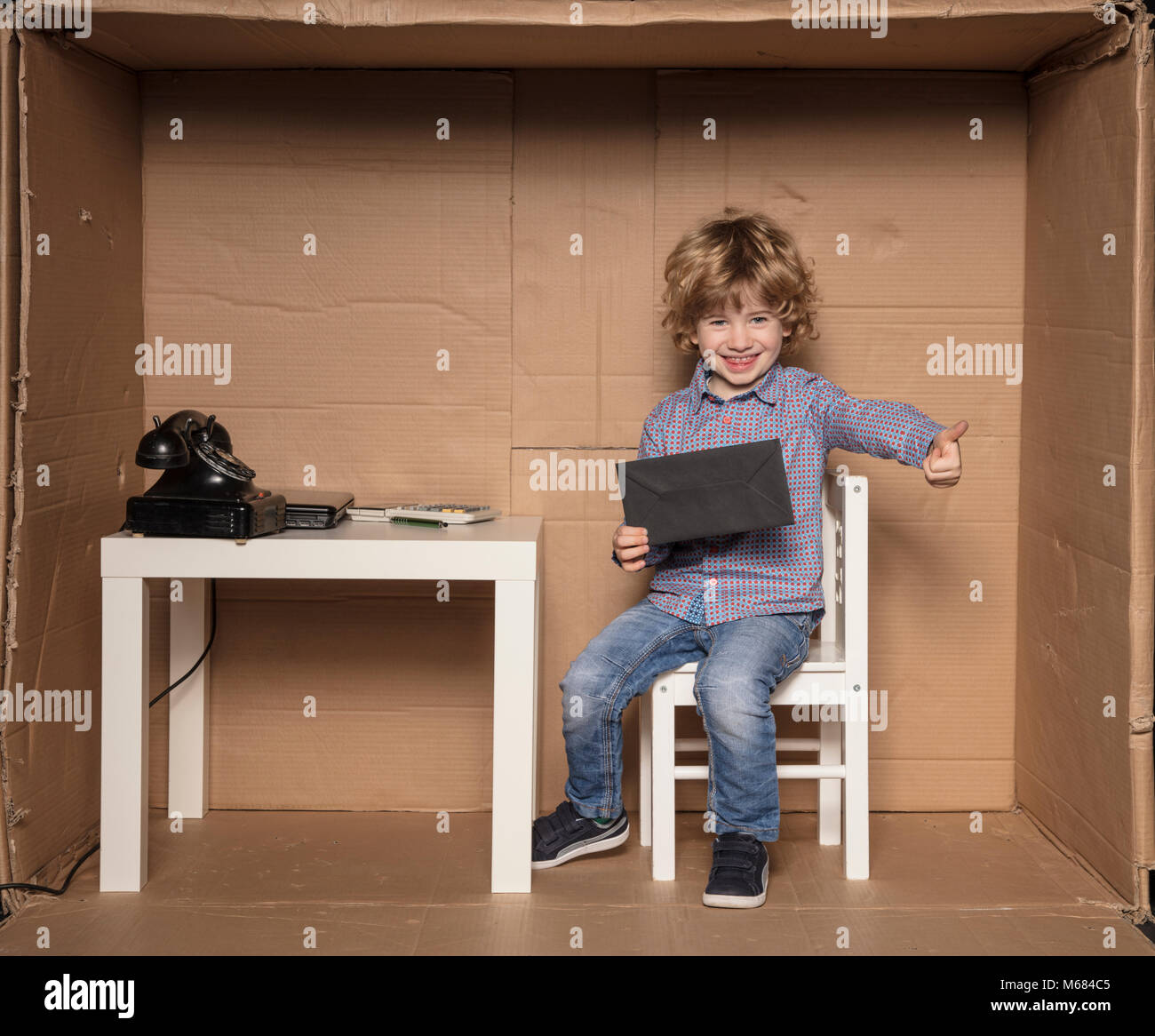 small businessman shows thumbs up, envelope in hand Stock Photo - Alamy