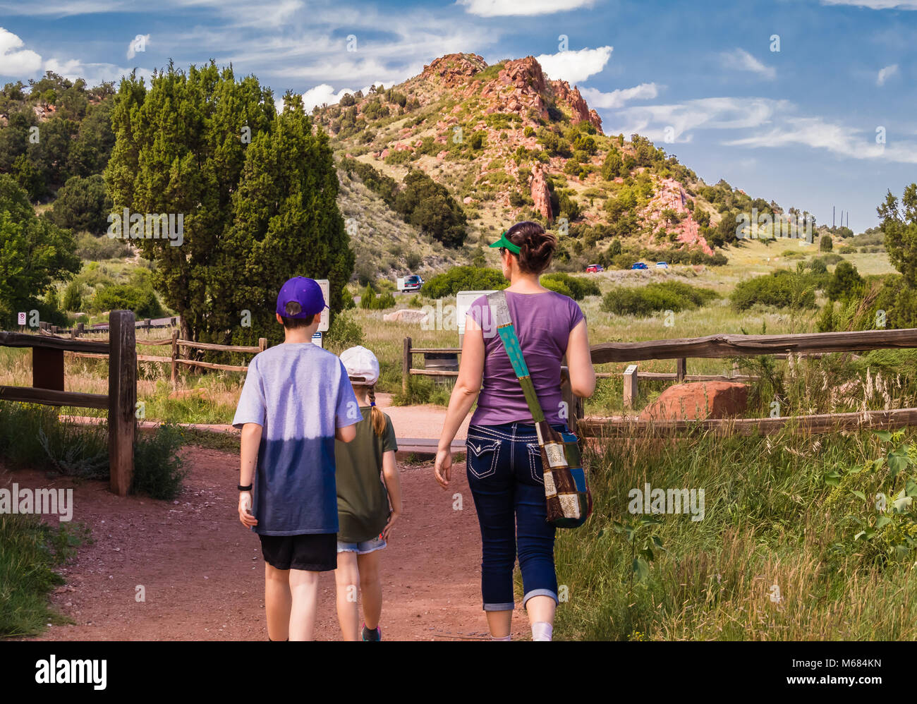 Young woman with two children walking around Garden of the Gods park in ...