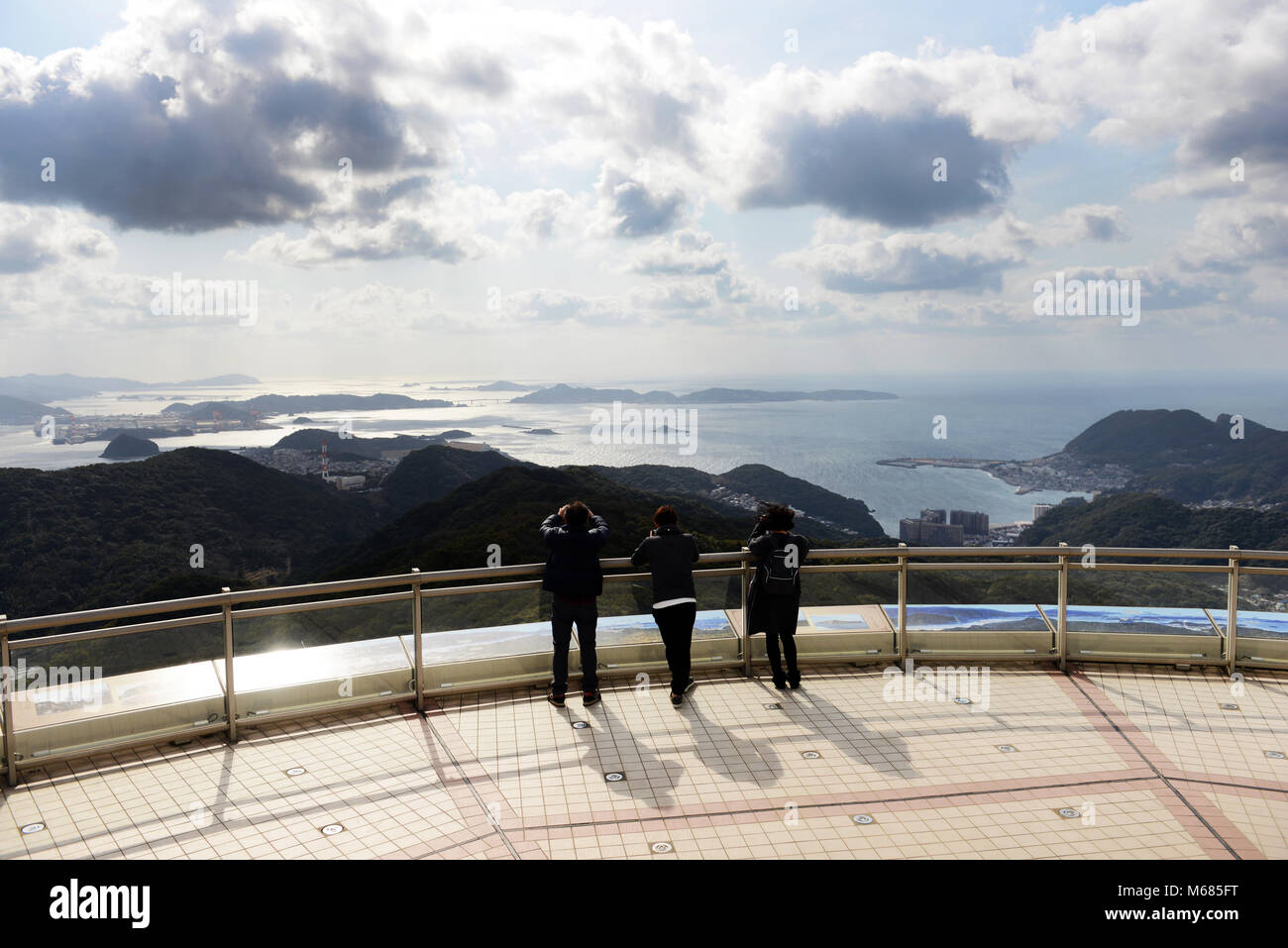 Tourist enjoying the views of Nagasaki from the top of Mount Inasa ...