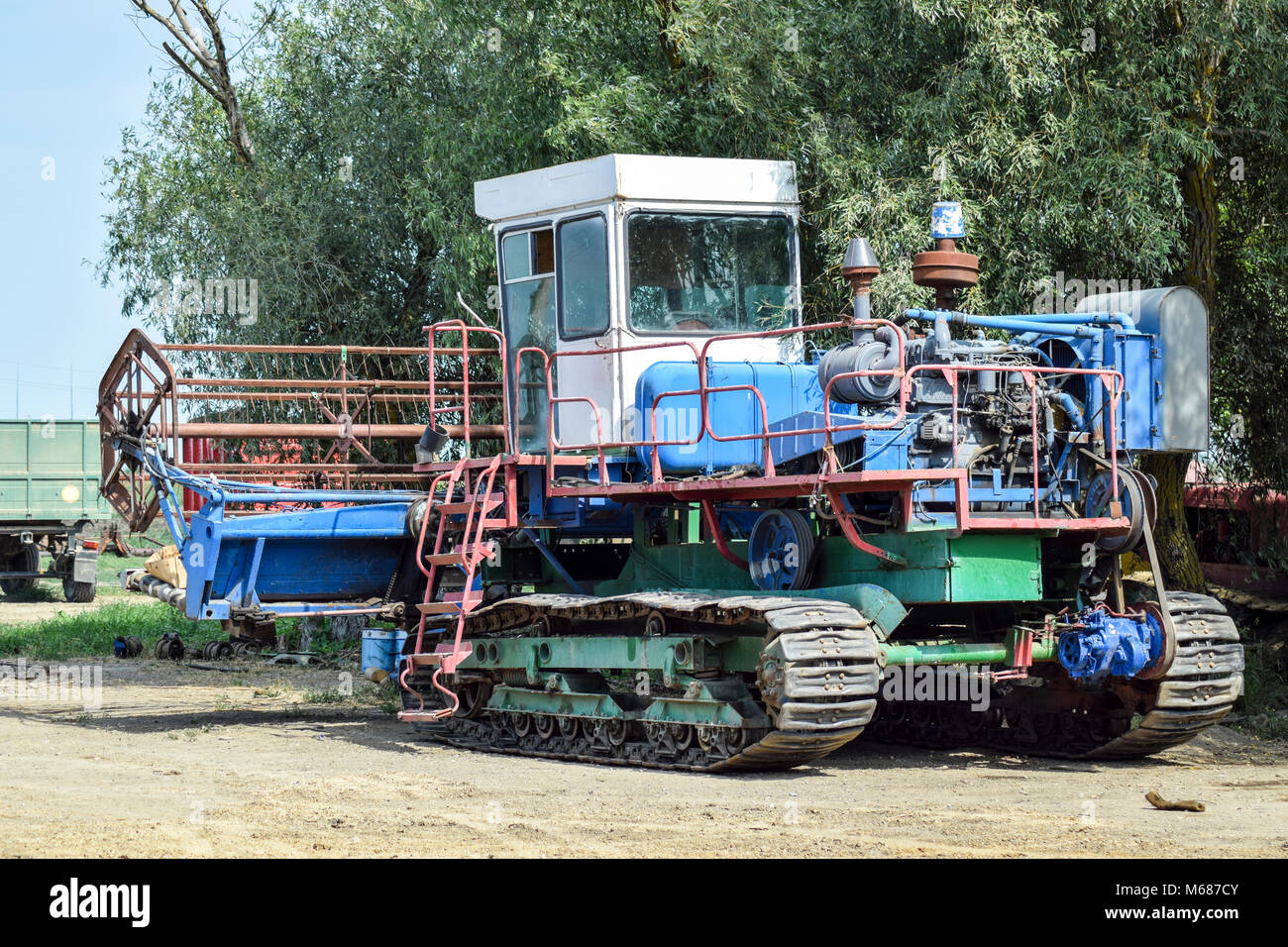 Rice header combine harvester. Old rusty combine harvester. Combine ...