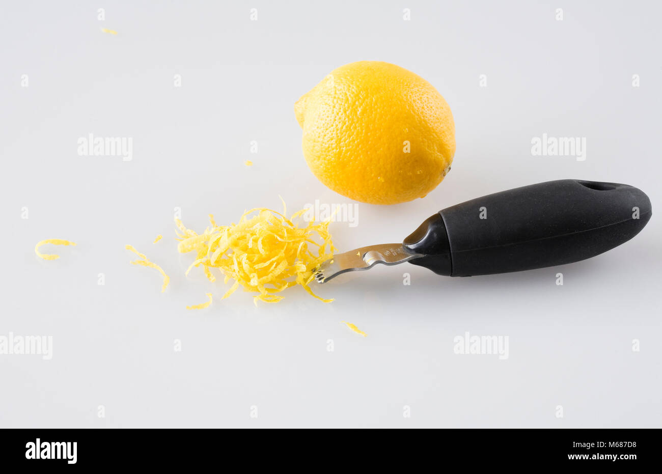 Lemon, zest and zester Stock Photo - Alamy