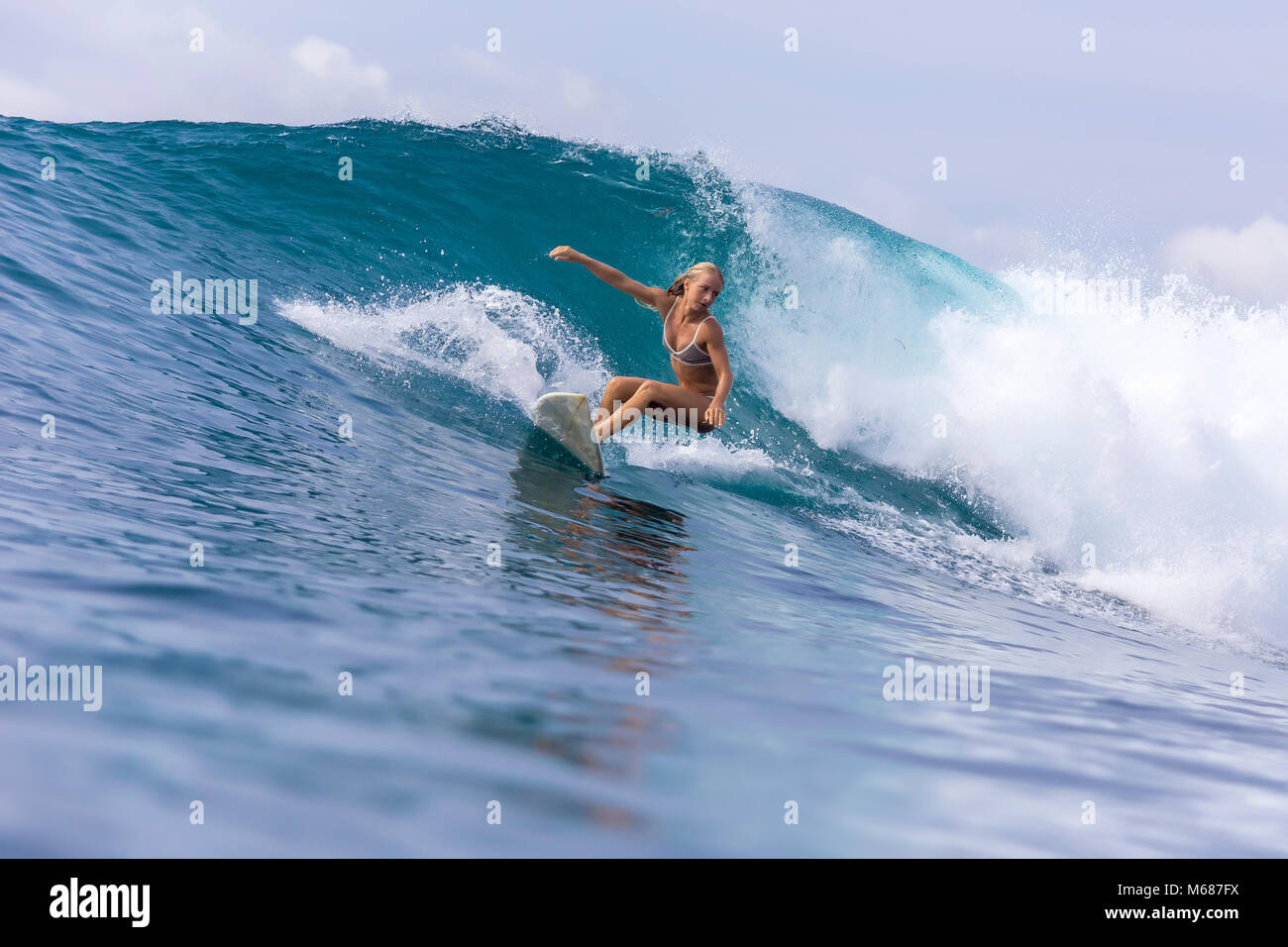Surfer girl on wave indonesia hi-res stock photography and images - Alamy
