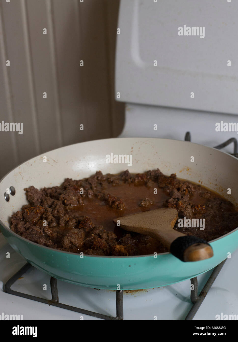 Cooked ground beef and a stirring spoon in a frying pan Stock Photo - Alamy