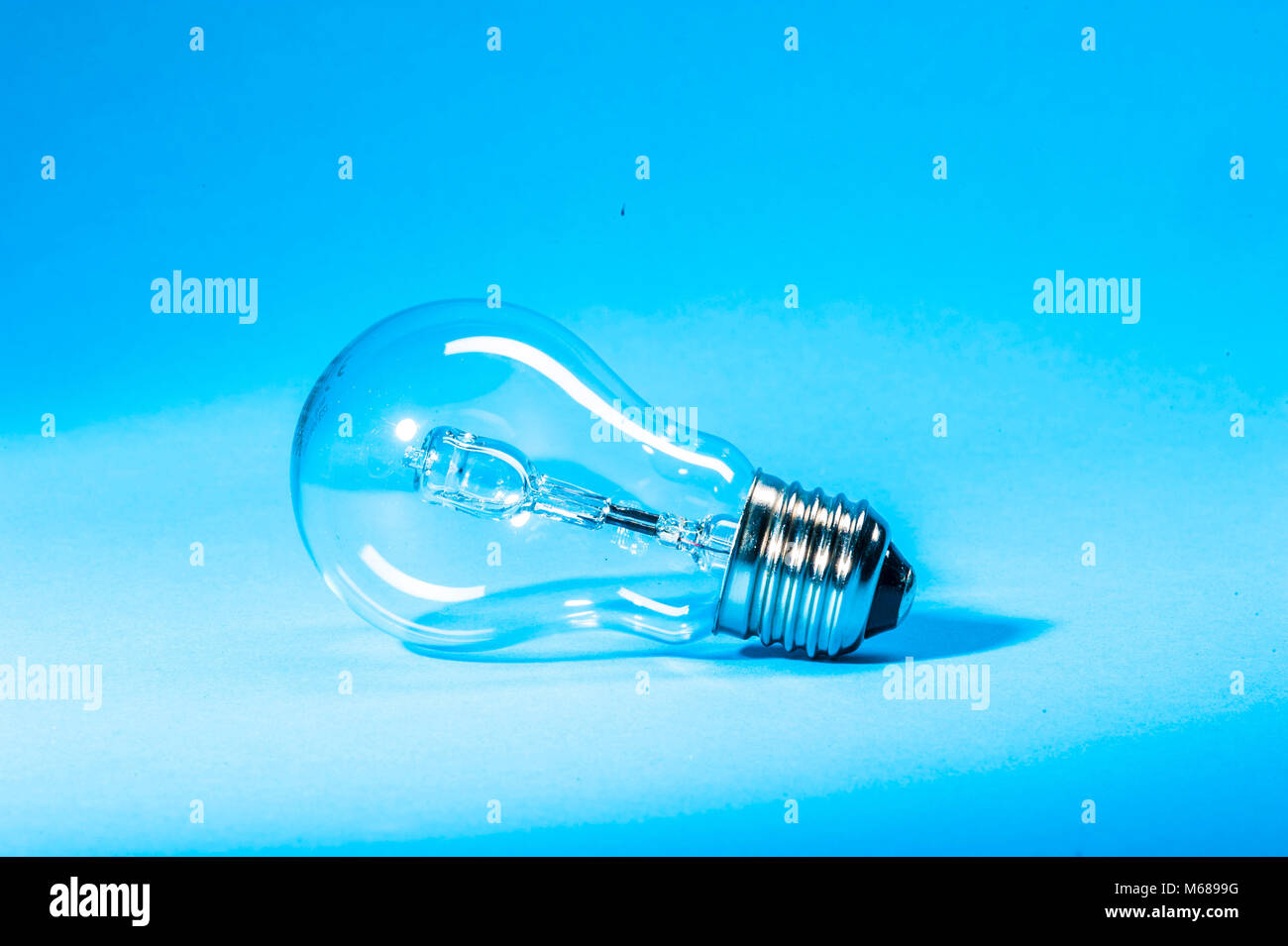 Light bulb on blue background Stock Photo - Alamy