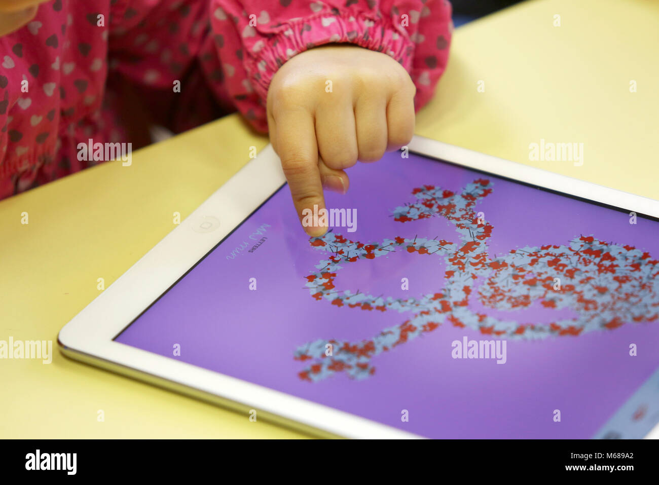 Nursery school: little girl, pupil, using a digital tablet (iPad Stock ...