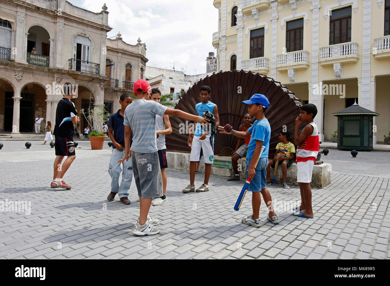 Cuban kids discussing the rules for their game of baseball in the Old ...