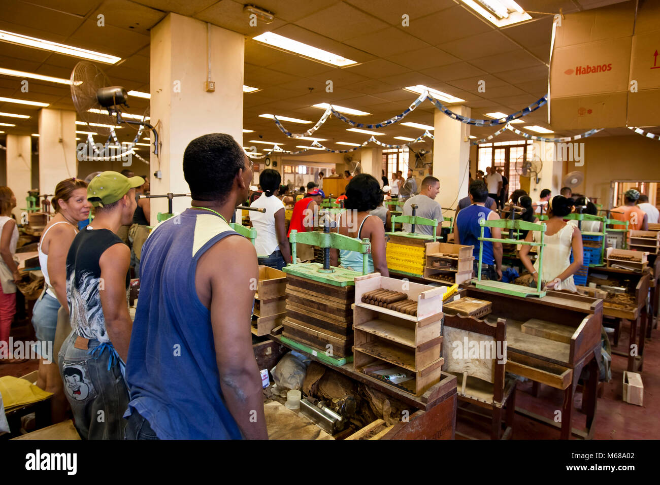 Cuban cigar factory workers hear the morning news at the H. Uppmann ...