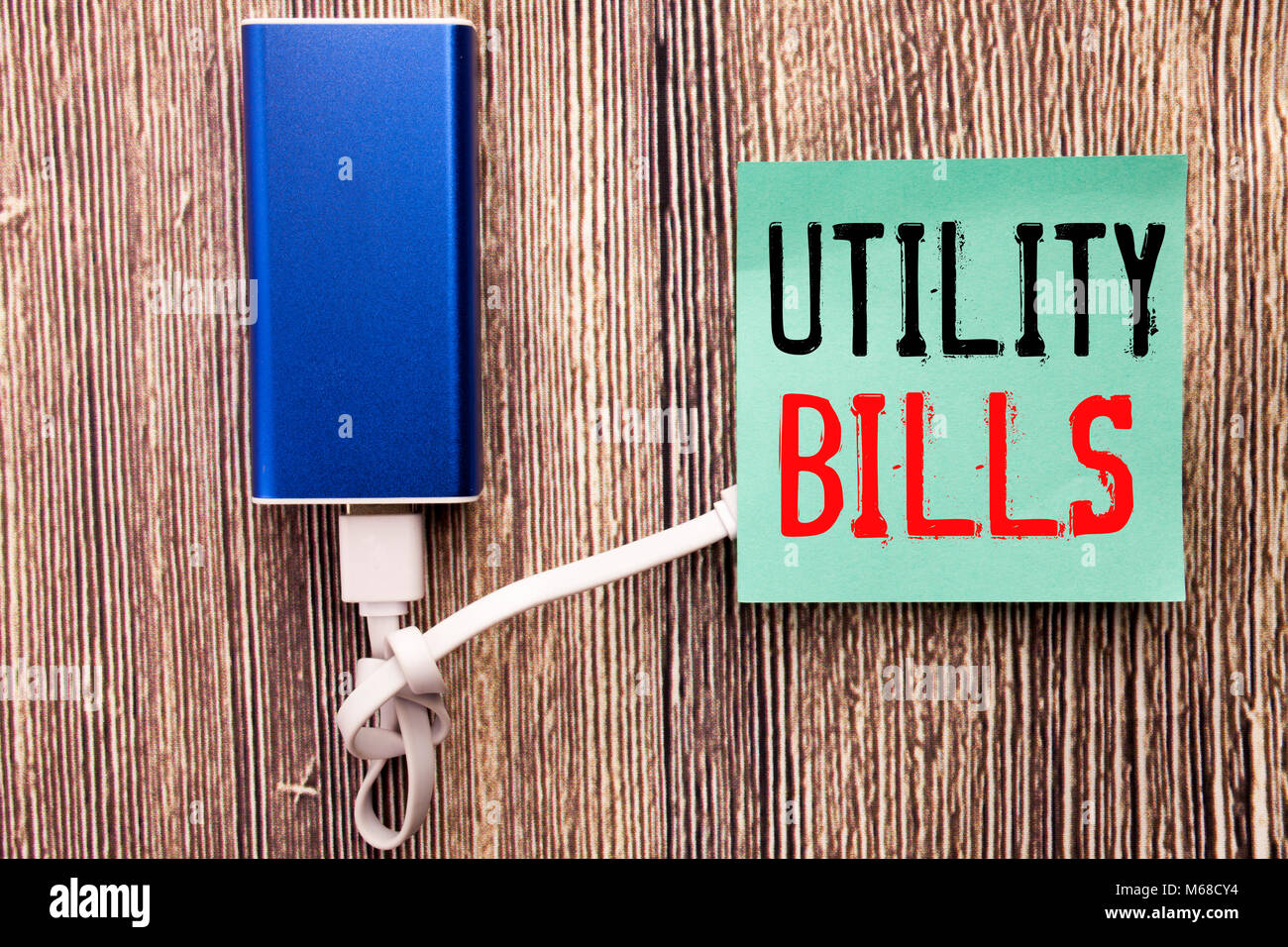 Handwritten text caption showing Utility Bills. Business concept ...