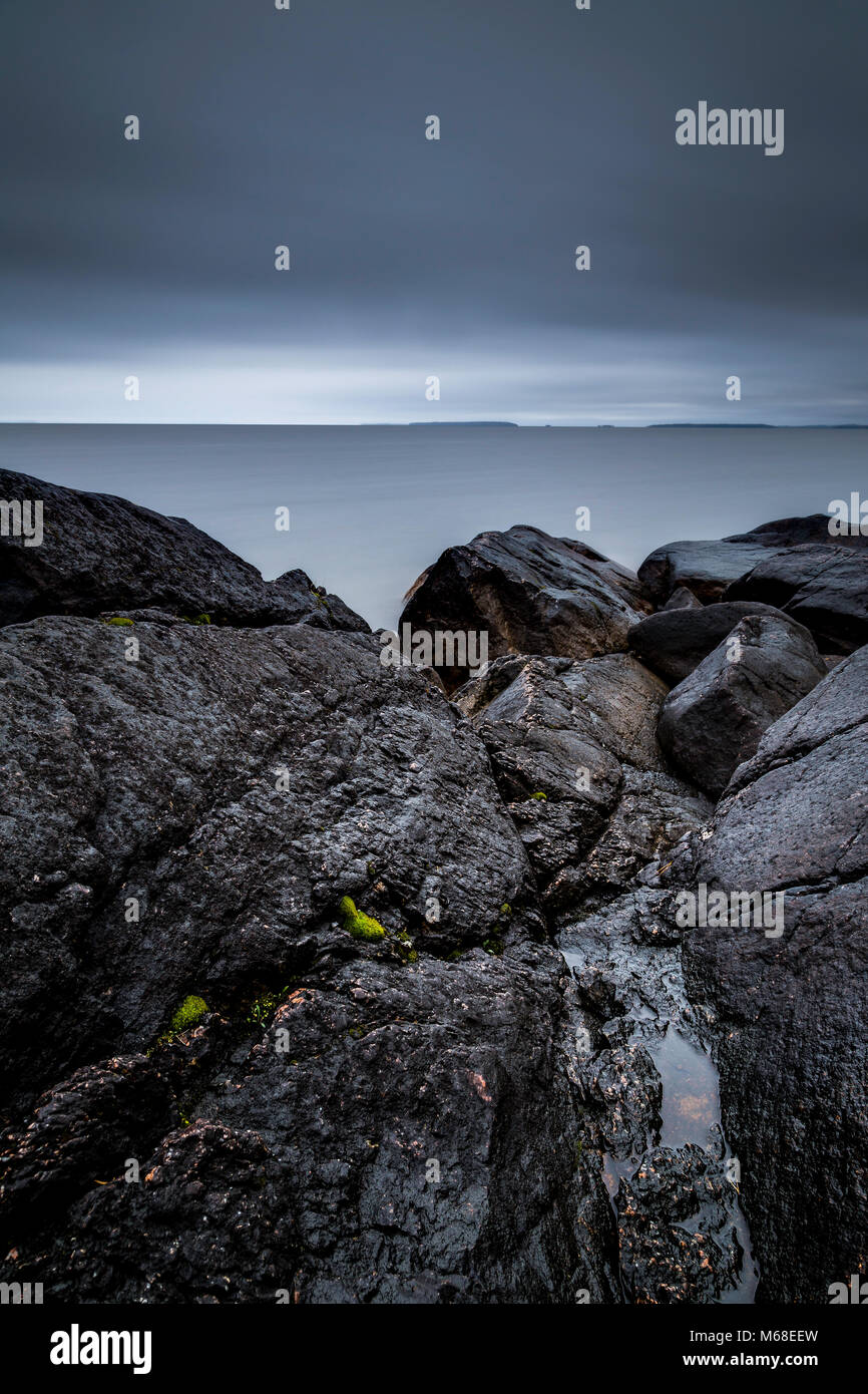 Long exposure of sea landscape with a rock in the foreground Stock ...