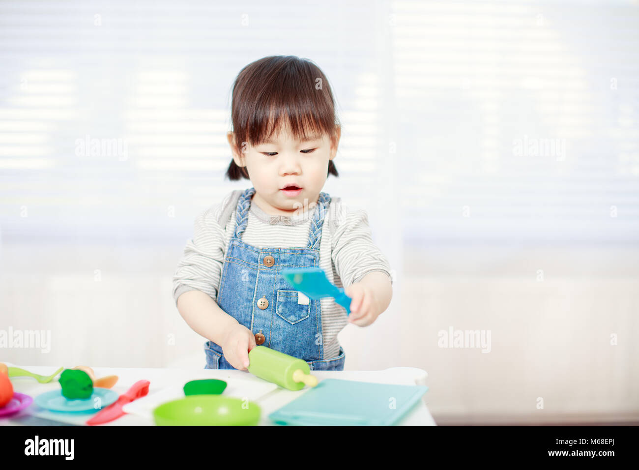 baby girl pretend play food toy Stock Photo - Alamy