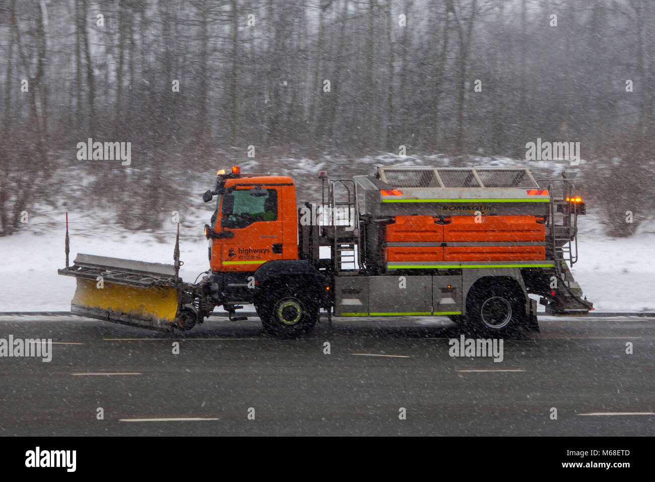 Snow plough clearing roads and spreading salt in Leeds West Yorkshire ...