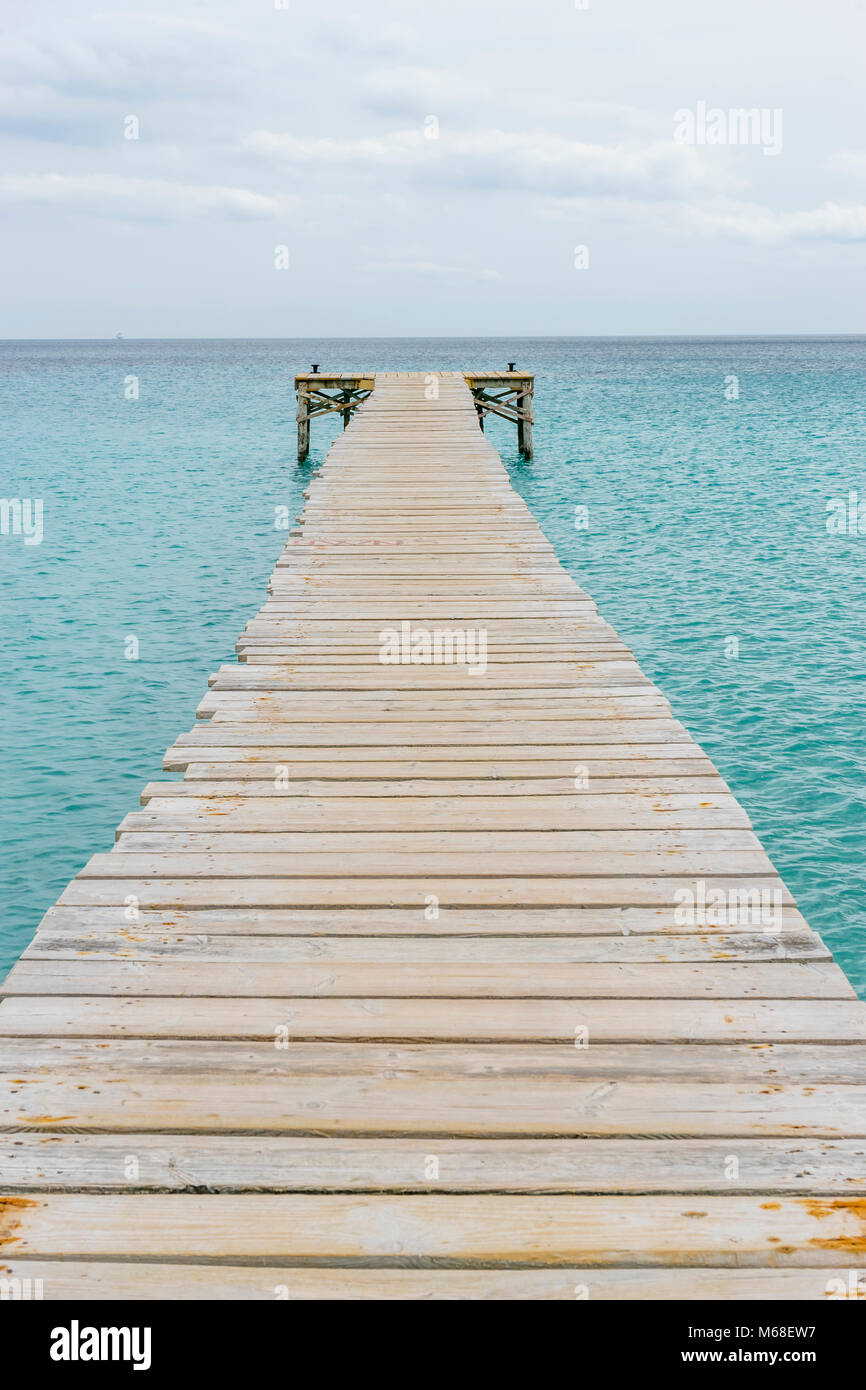 Wooden pier next to the Mediterranean sea on the island of Ibiza in ...