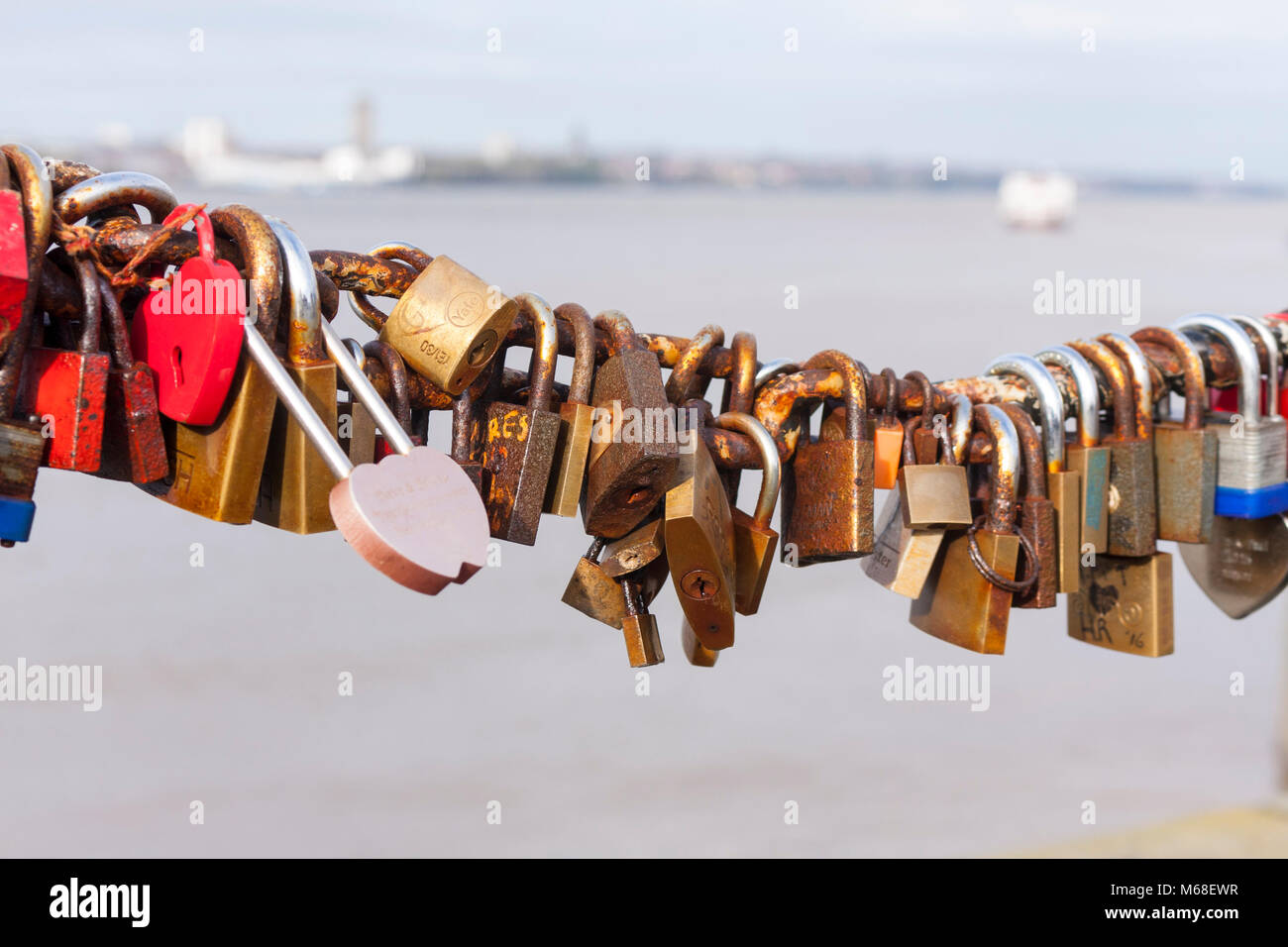 Love locks on a chain fence across a bridge. Albert Dock, Liverpool ...