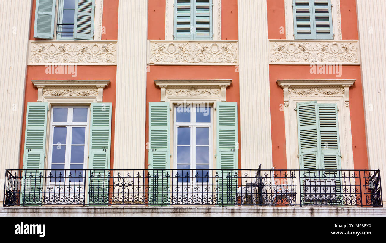Facade of a historic building with french windows and a balcony Stock ...