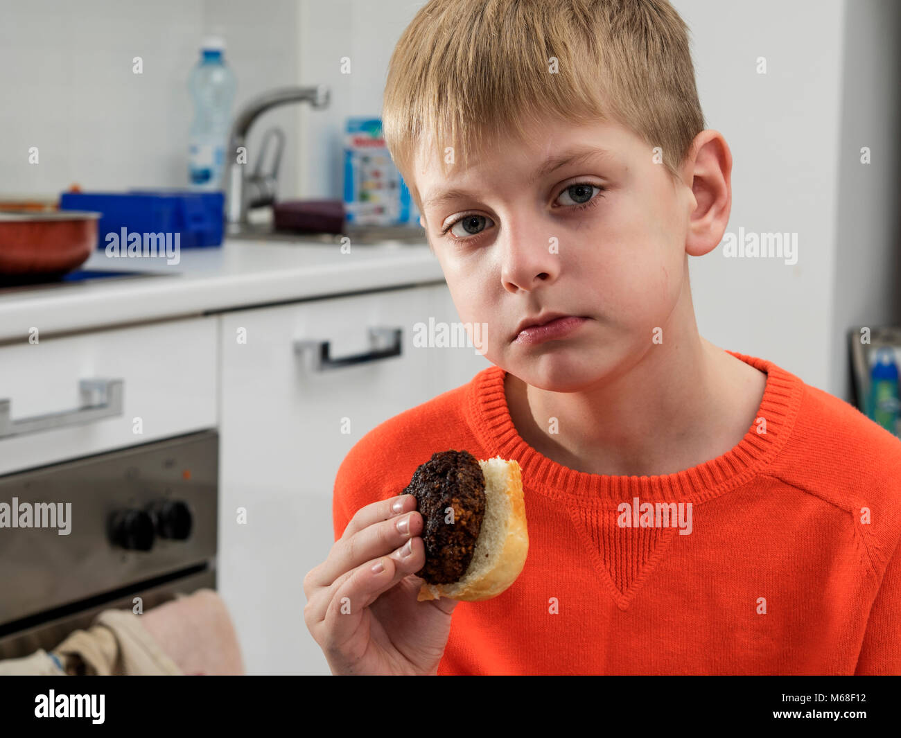 Boy eating meat sandwich hi-res stock photography and images - Alamy