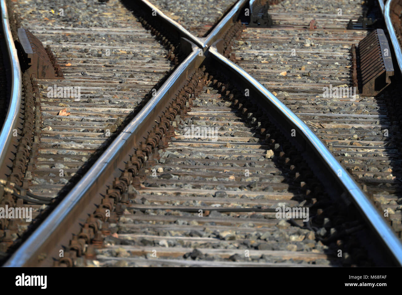 a crossing of train tracks seen from up close of railway line in Spain ...