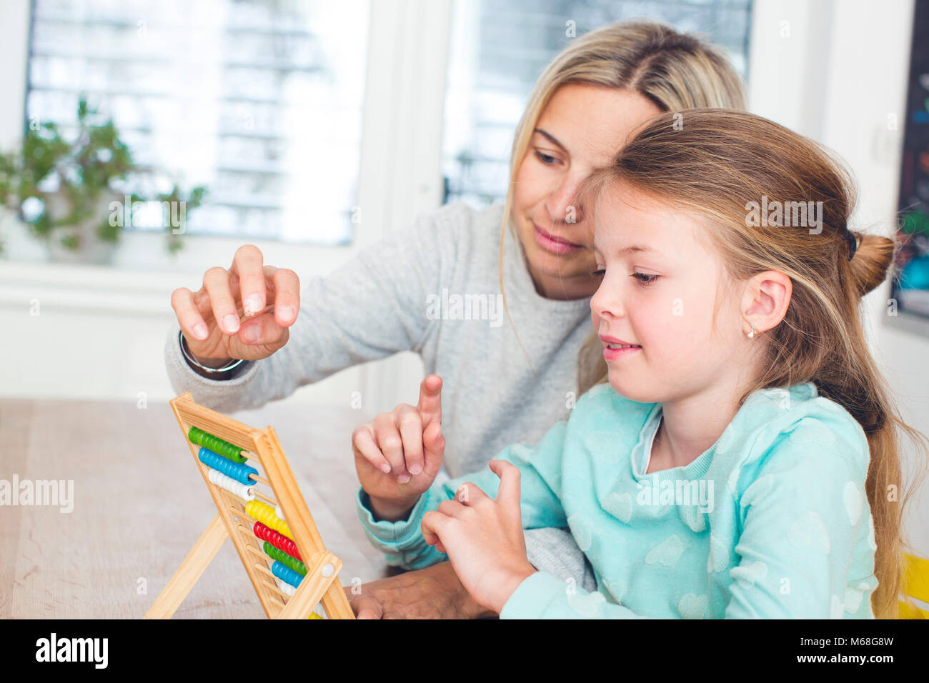 mother learns mathematics with the child using the calculator Stock ...