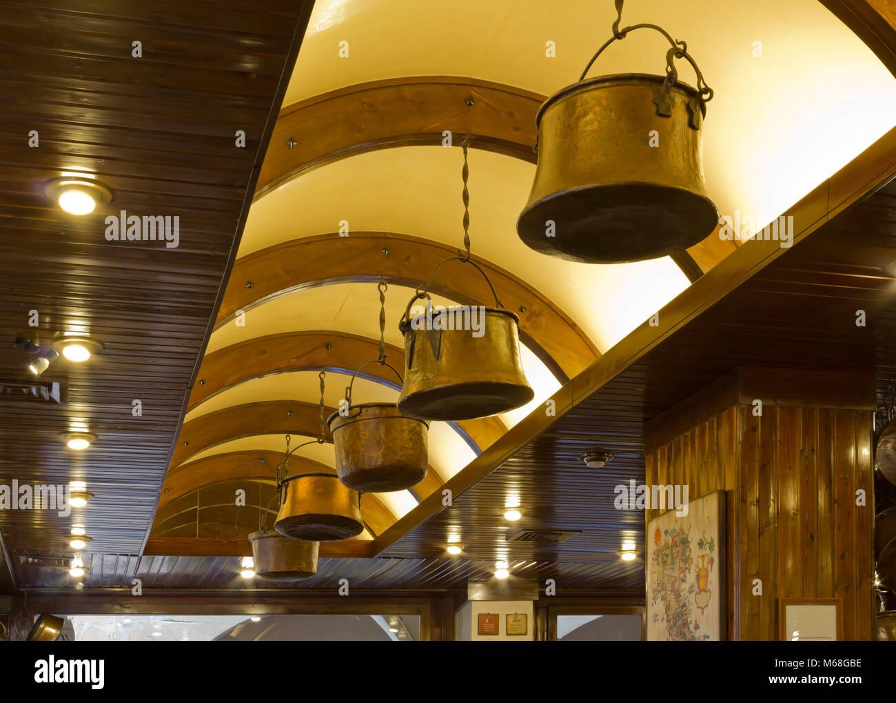 Set of traditional copper pots hanged on an arched ceiling Stock Photo ...