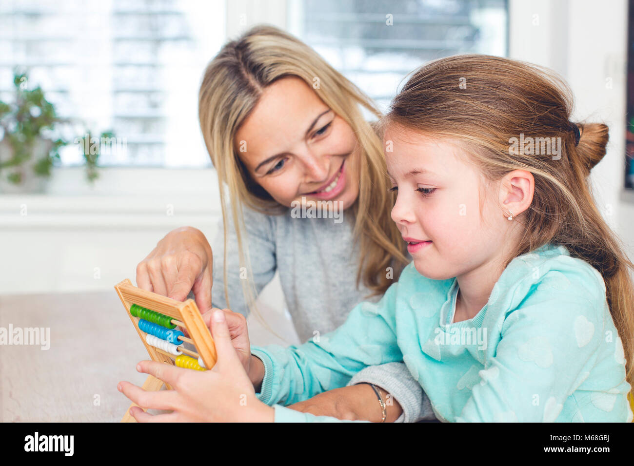 mother learns mathematics with the child using the calculator Stock ...