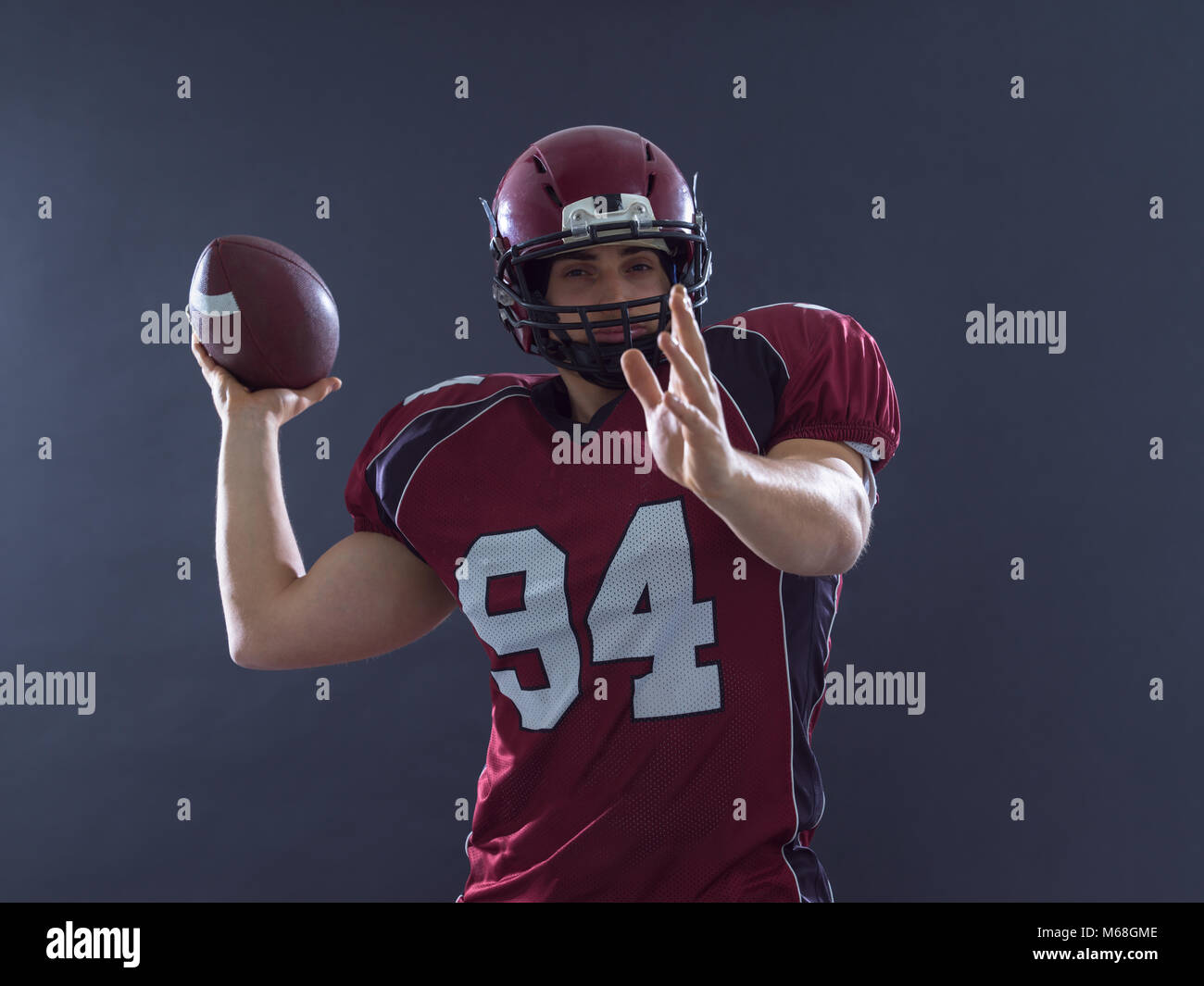 one quarterback american football player throwing ball isolated on gray ...